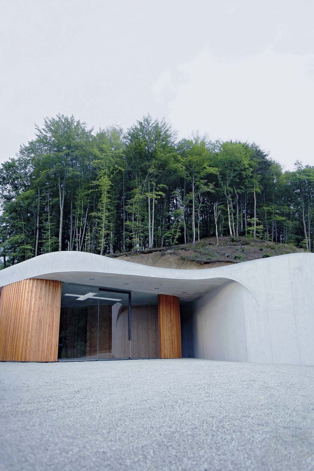 A Curved Concrete Chapel By OFIS Architects - IGNANT